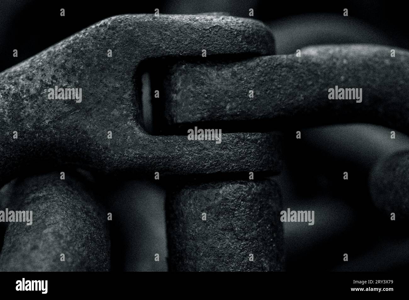 Large metal chains linked together stacked in an industrial yard ...