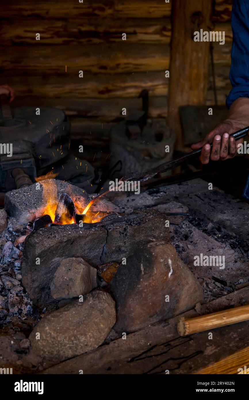 Blacksmith working metal with hammer on the anvil in the forge Stock ...