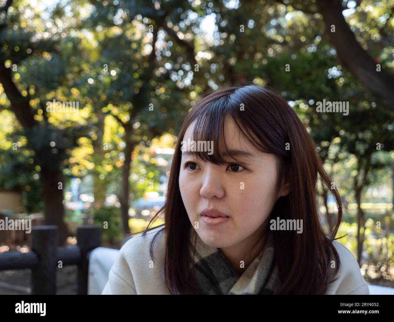 A Beautiful young Japanese woman looking shocked in winter clothes ...