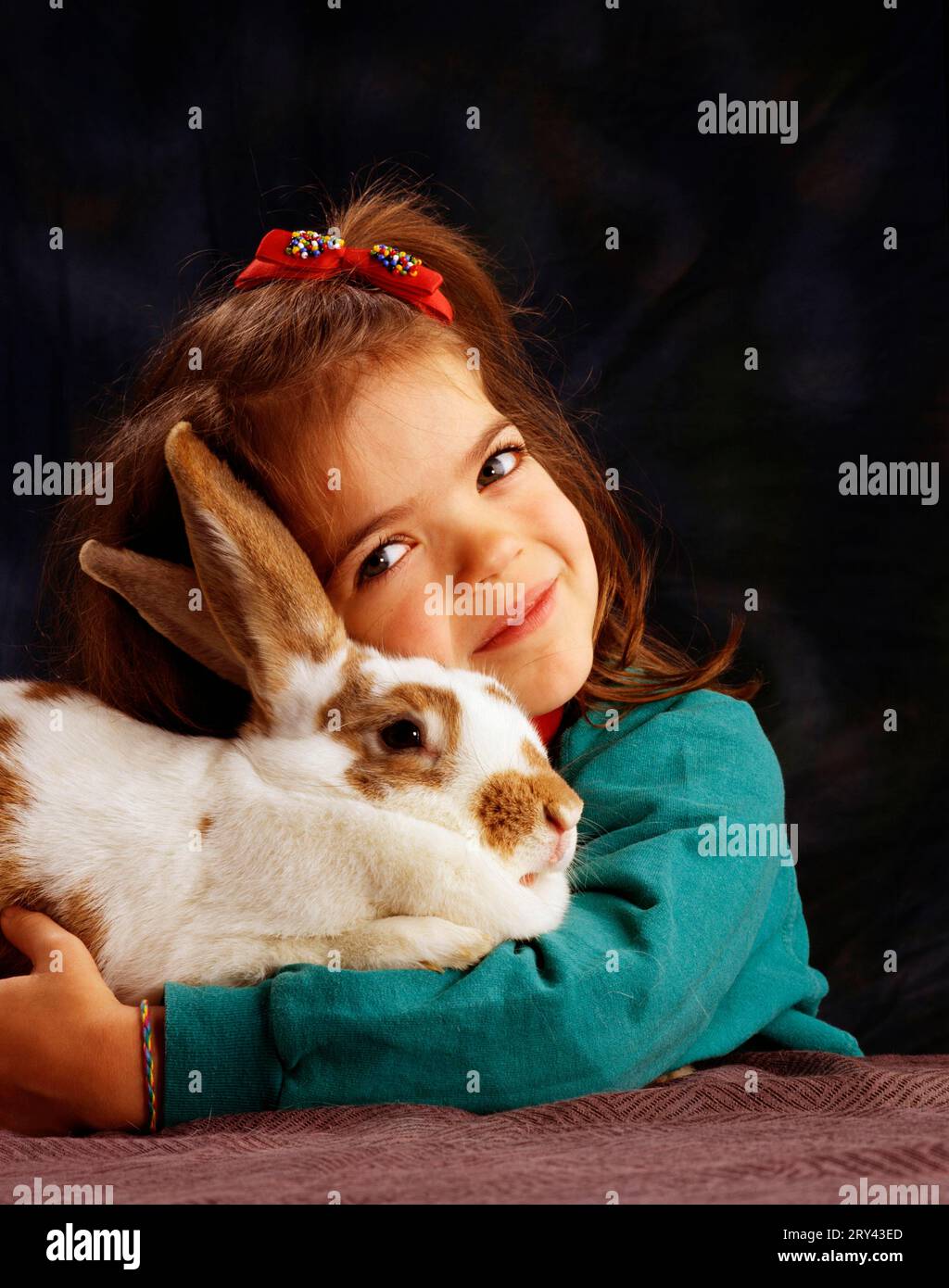Girl cuddles with pet rabbit Stock Photo - Alamy
