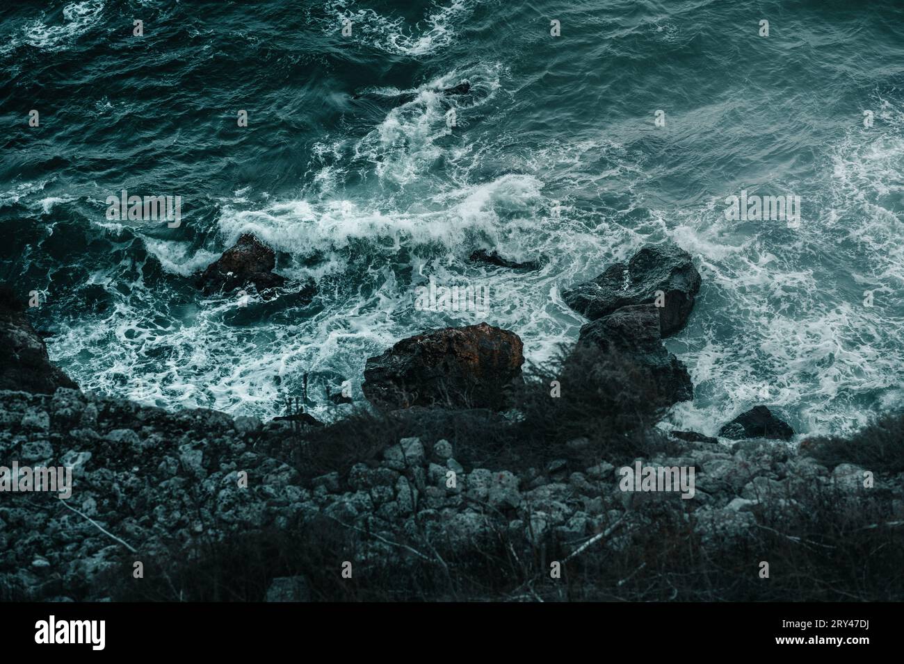 Sea water hitting rocks Stock Photo - Alamy