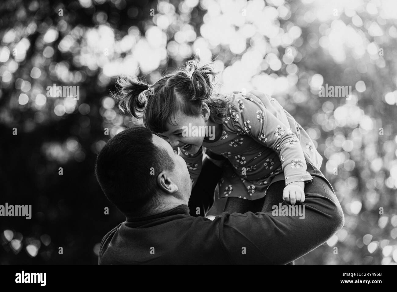 Happy fathers day. Joyful dad throws up his little smiling daughter at ...