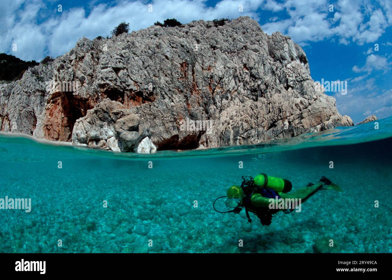Diver in front of rocky coast, Croatia, diver in front of cliff, under ...
