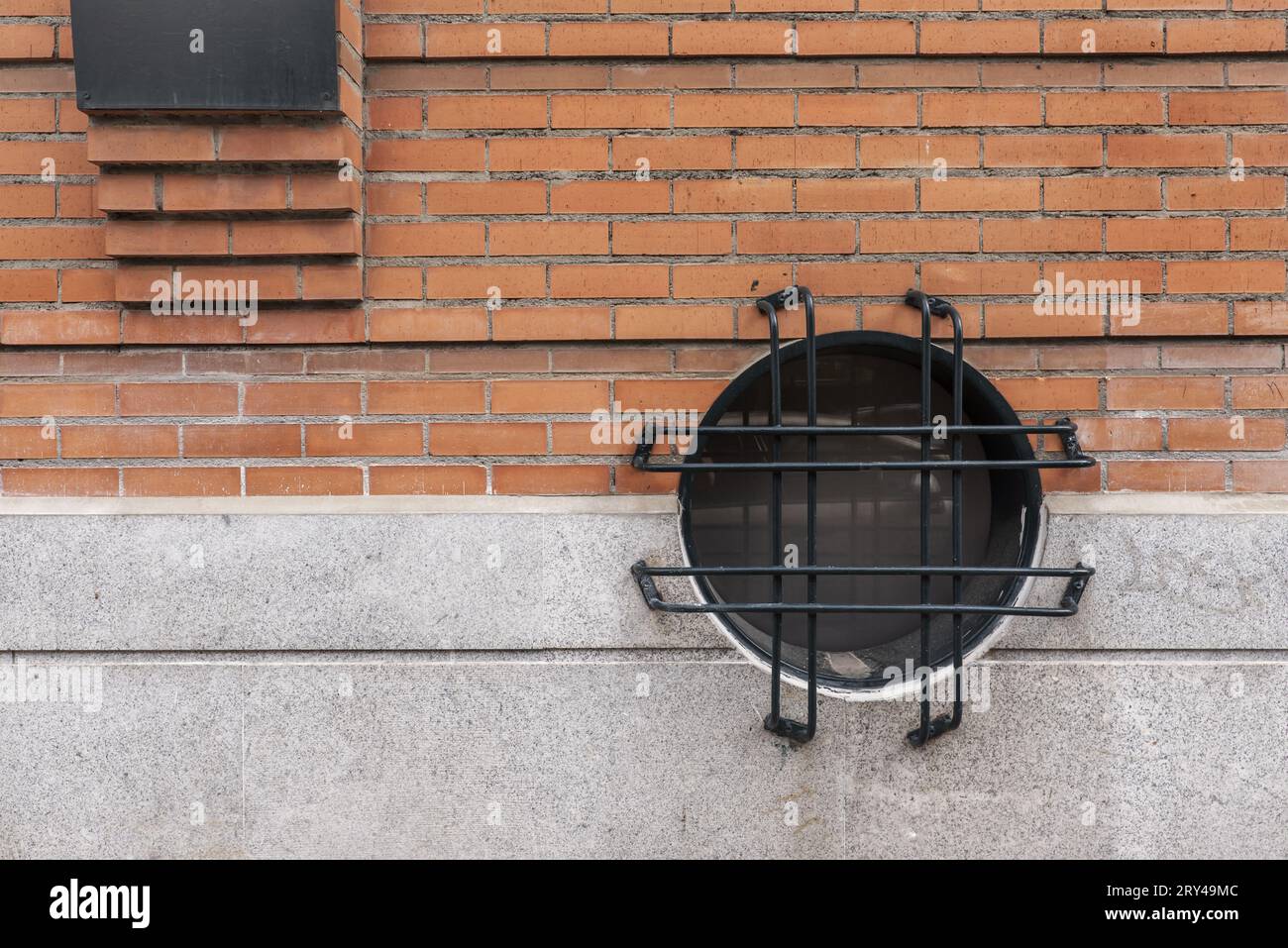 A circular window with metal bars painted in green Stock Photo - Alamy