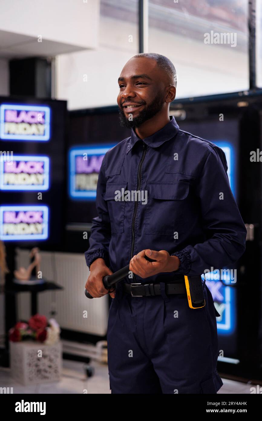 Smiling friendly African American security guard wearing uniform ...