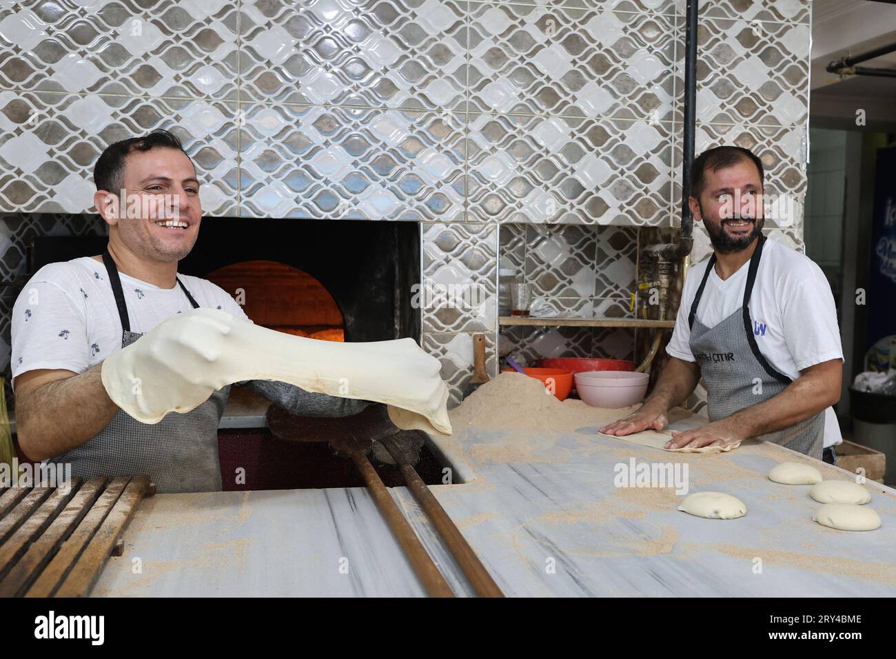 Bakers making traditional Turkish flatbread in the Fatih district of ...
