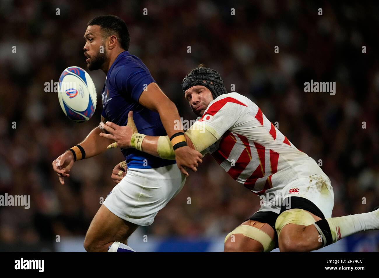 Samoa's Duncan Paia'aua, left, is tackled by Japan's Pieter Labuschagne ...