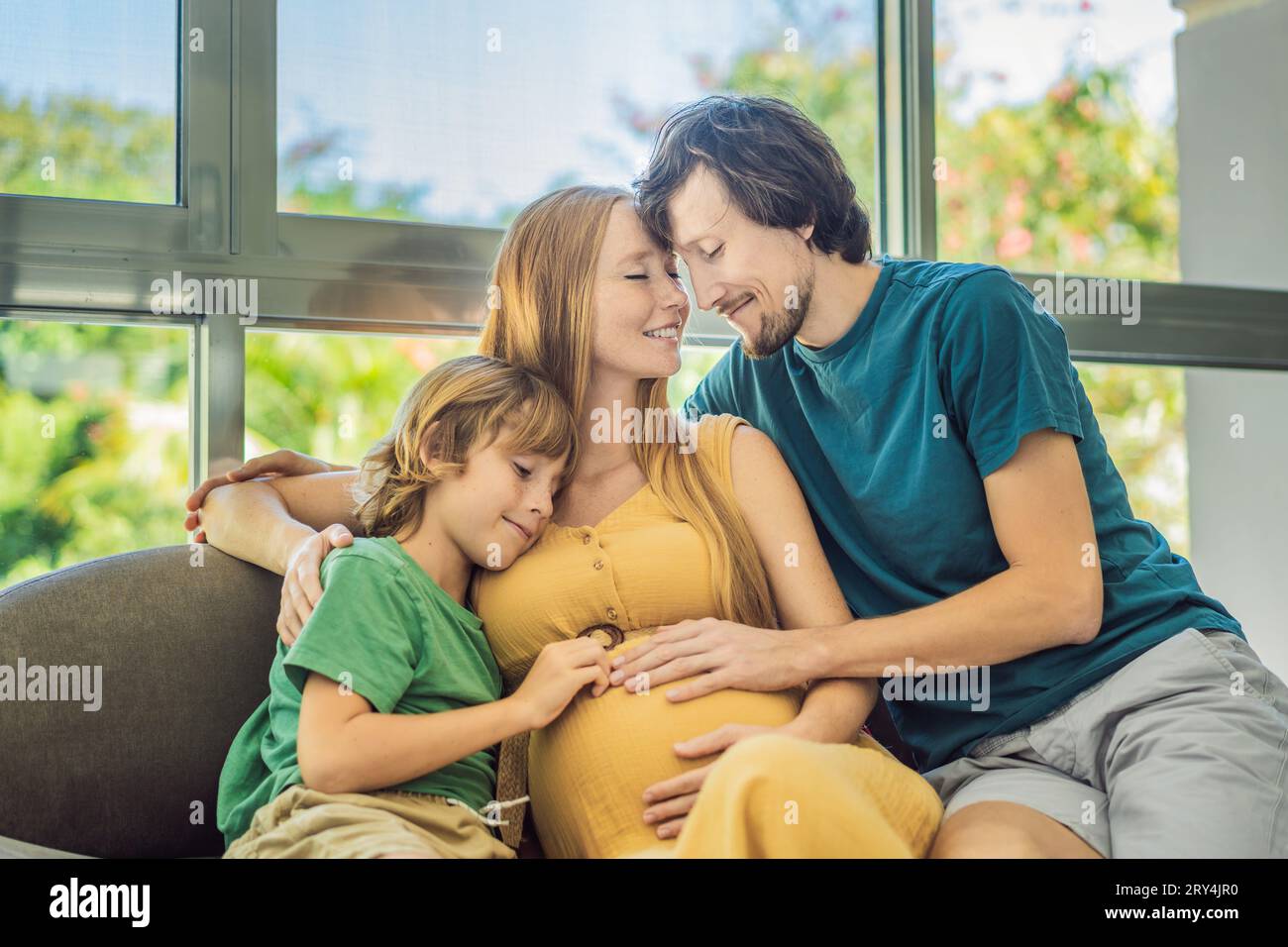 Expectant parents, mom, dad, and their eldest son share a heartwarming ...