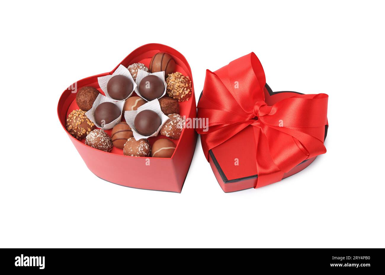 Heart shaped box with delicious chocolate candies isolated on white ...