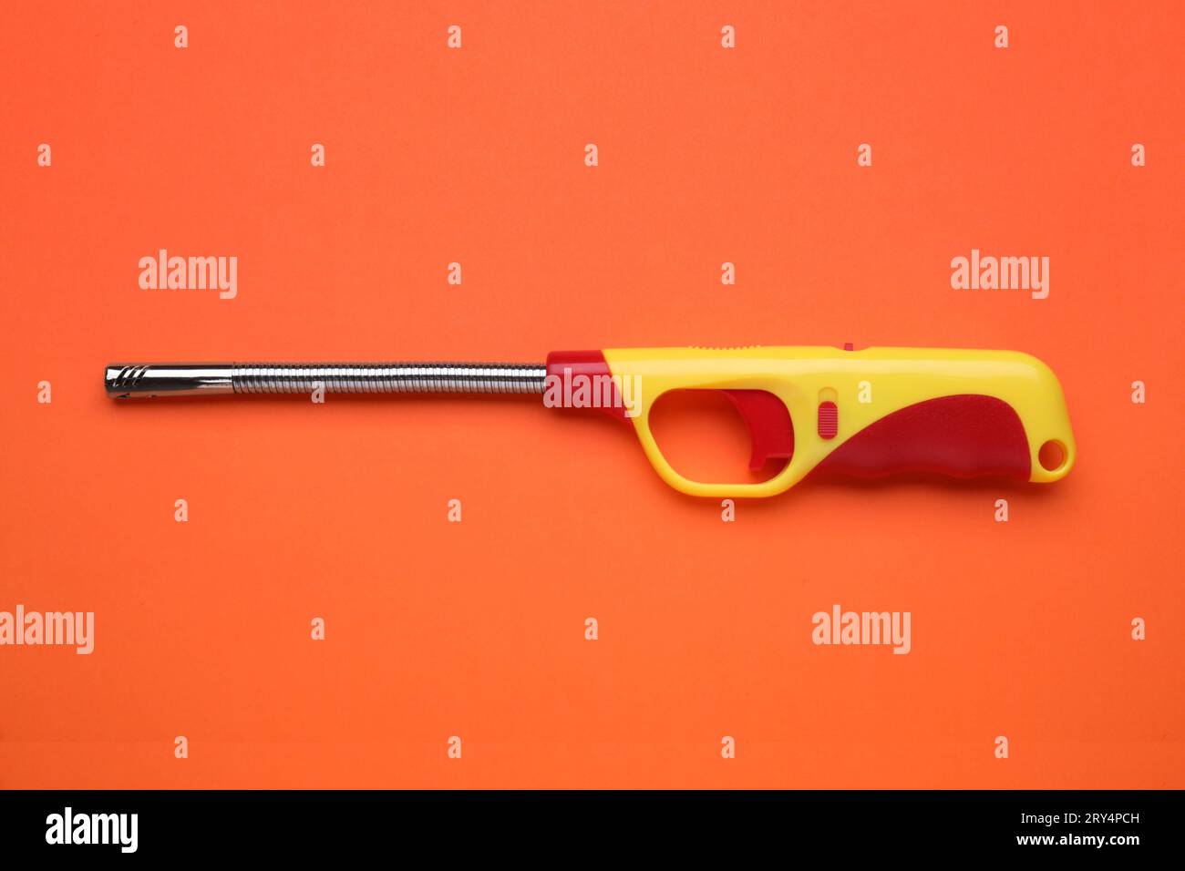 One gas lighter on orange background, top view Stock Photo - Alamy