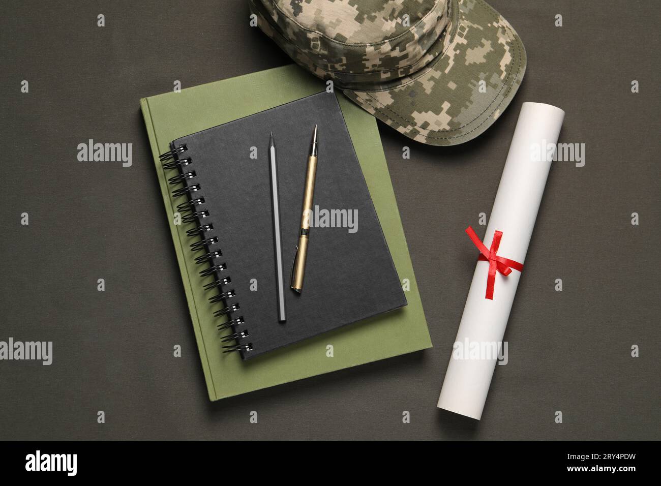 Stationery, soldier cap and diploma on dark background, flat lay ...
