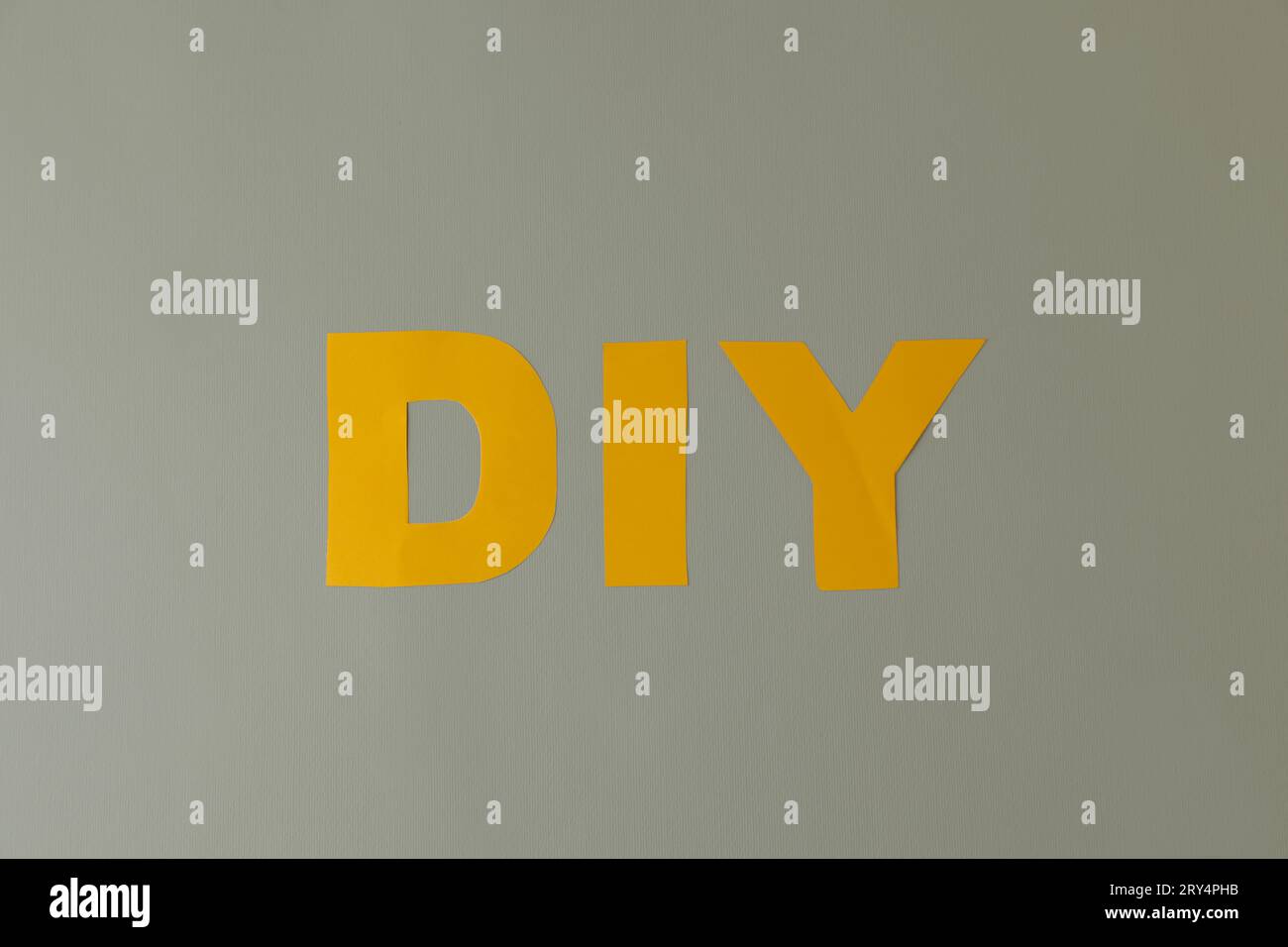 Abbreviation DIY made of letters on light grey background, flat lay ...