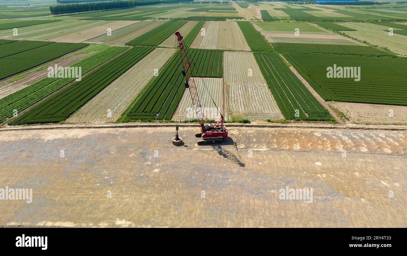 Dynamic compaction machine at the construction site, aerial photos ...
