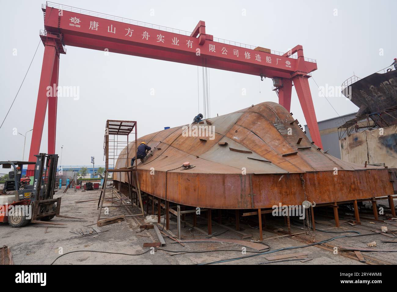 Luannan County, China - May 26, 2023: Workers welding hull steel plates ...