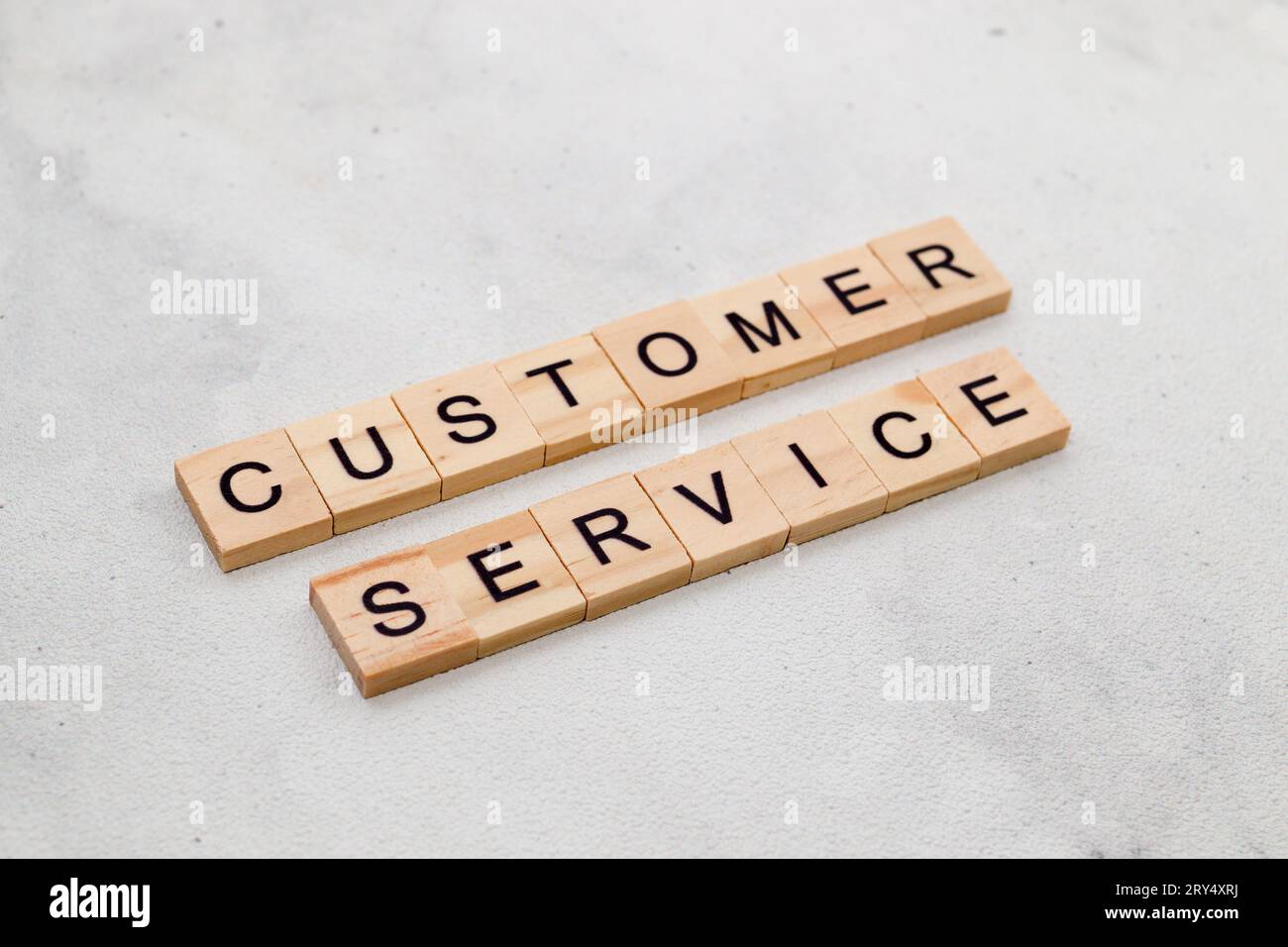 Top view of Customer Service word on wooden cube letter block on white ...