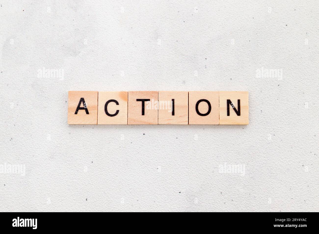 Top view of Action word on wooden cube letter block on white background ...