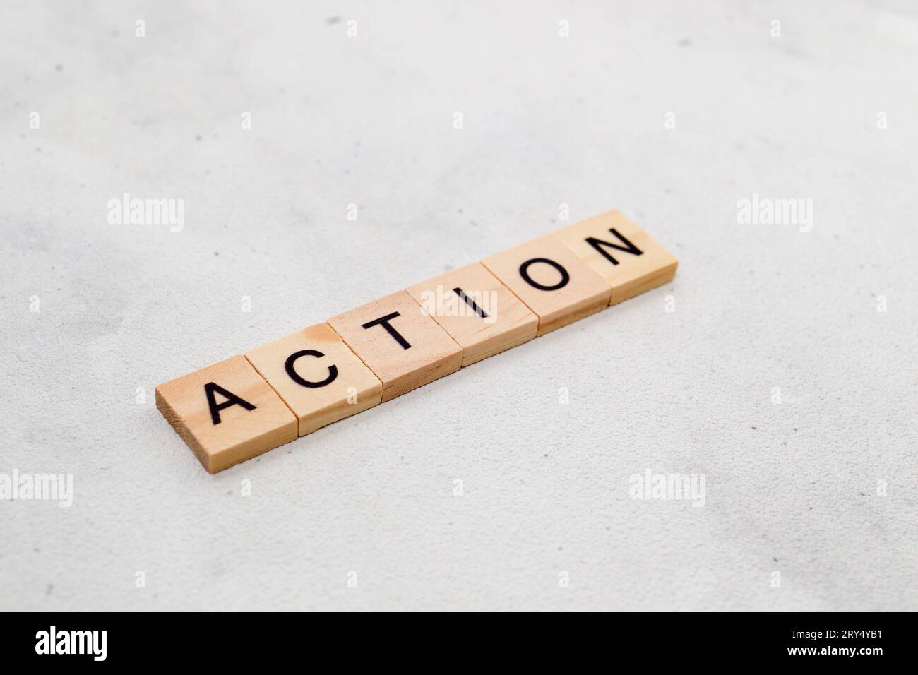 Top view of Action word on wooden cube letter block on white background ...