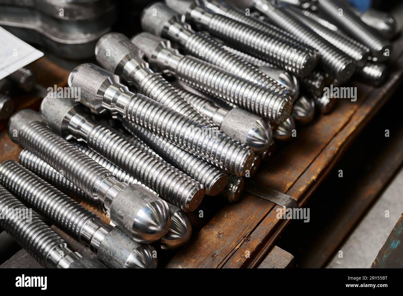 Sparkling crank pins with thread on old wooden table Stock Photo - Alamy