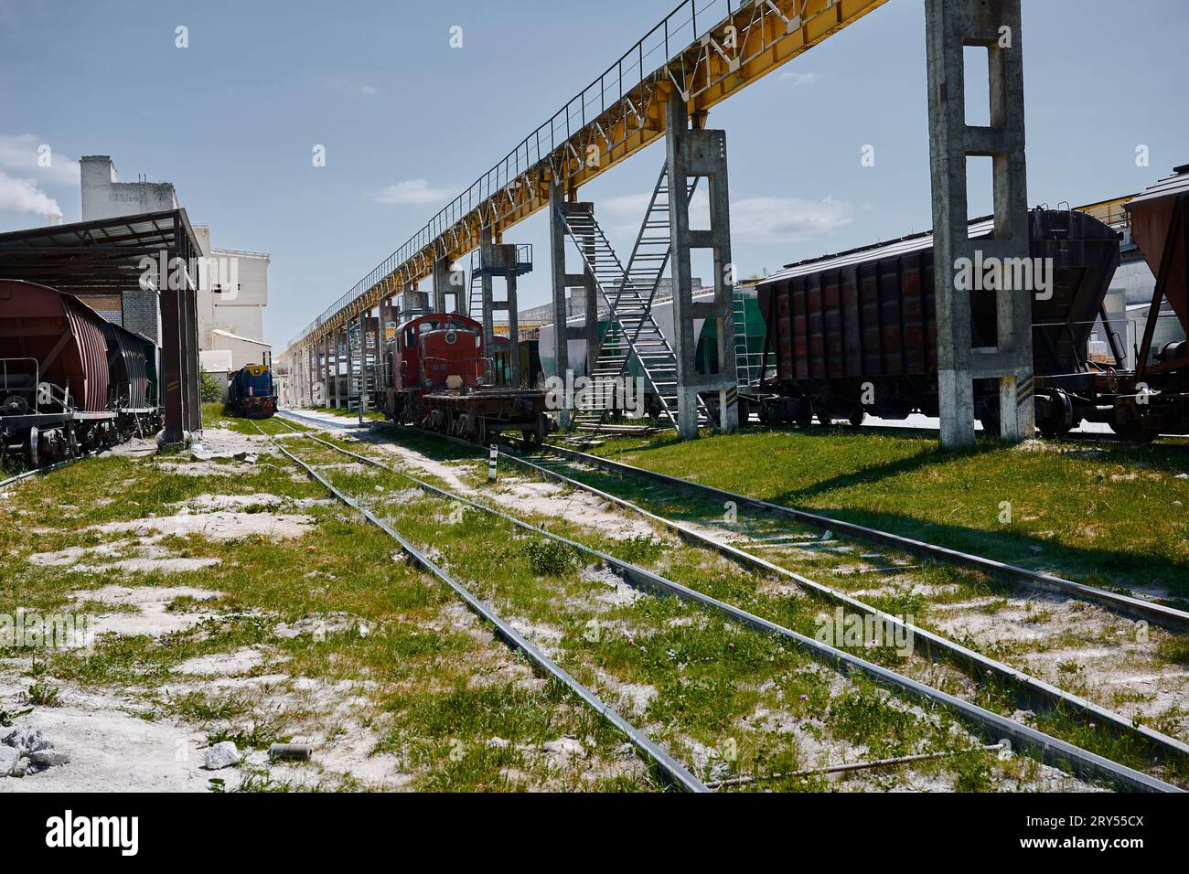 Small diesel locomotive on railway tracks in factory yard Stock Photo ...