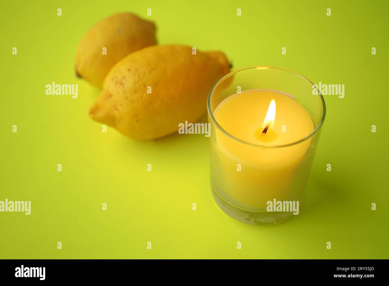 yellow color candle and lemon on black background Stock Photo - Alamy