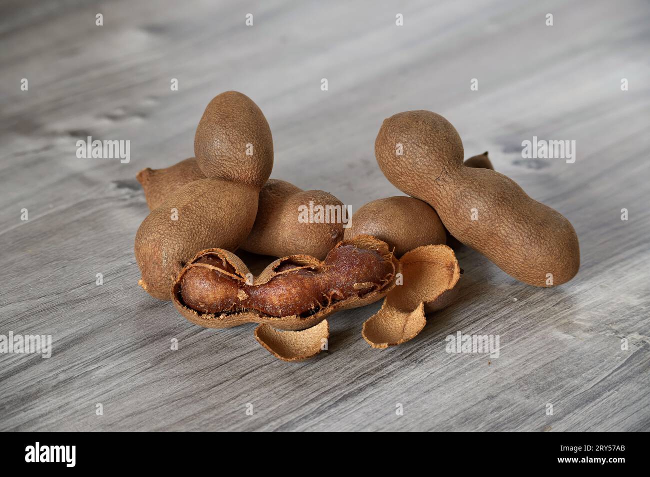 Rustic scene of a group of brown sweet tamarind fruits spread across a ...