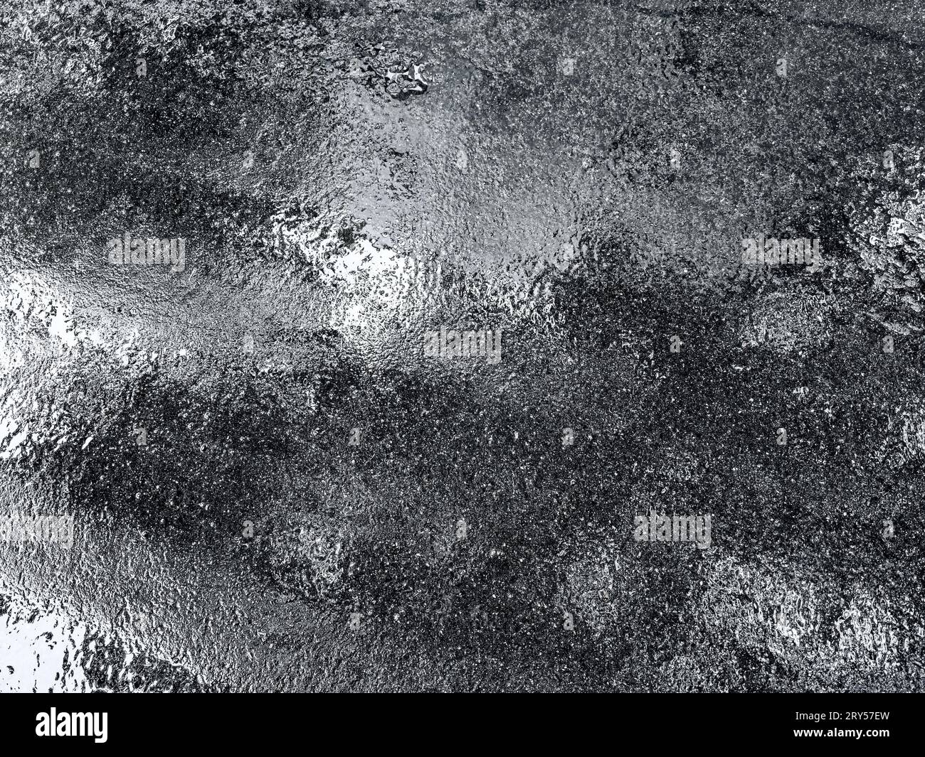 flooded road during rain with puddles and sky reflections. urban rainy ...