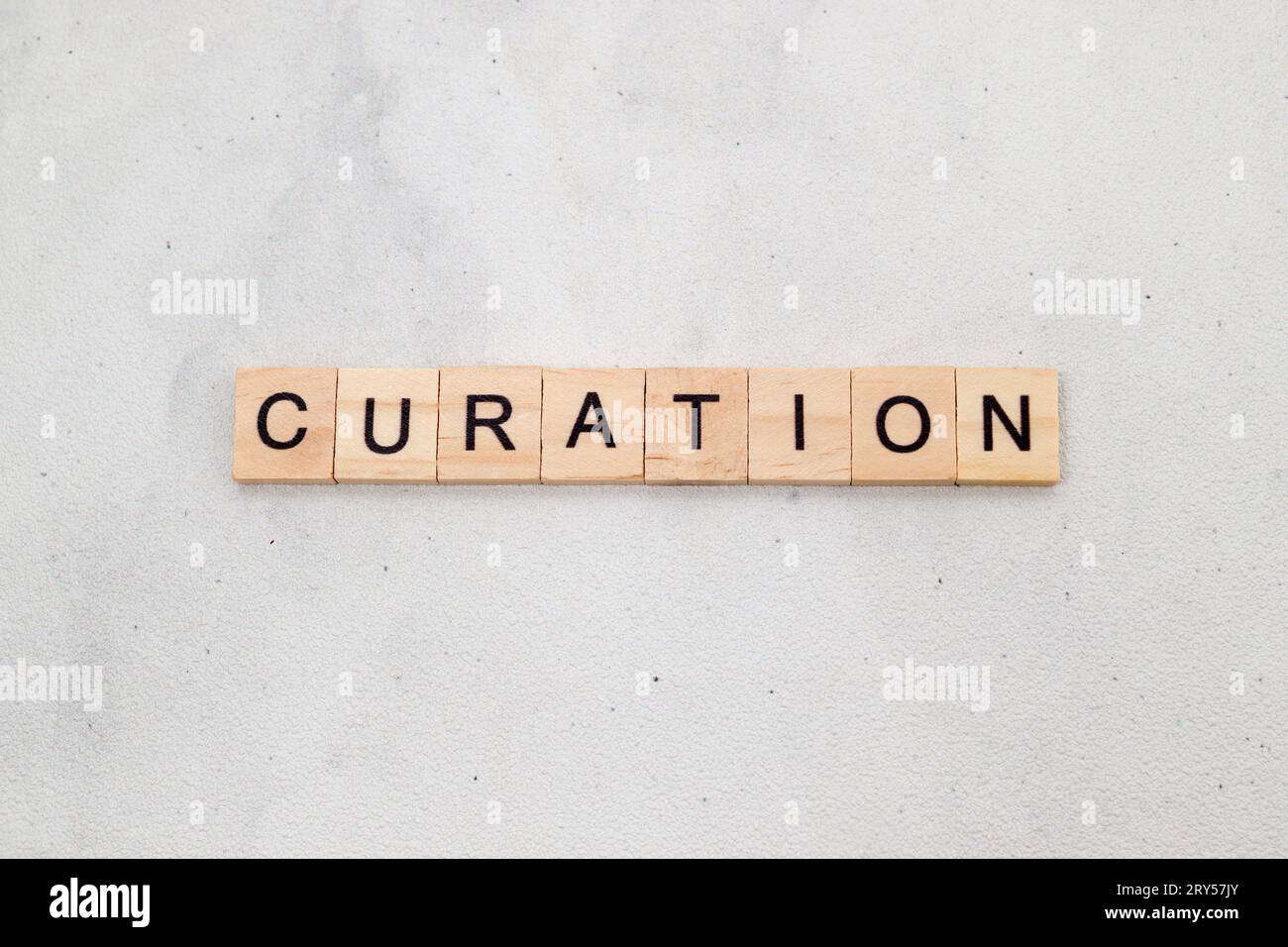 Top view of Curation word on wooden cube letter block on white ...