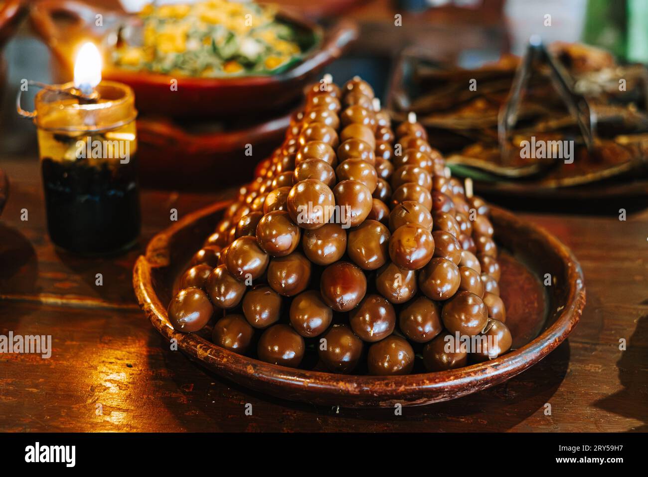 Sate Telur Puyuh or Brown Quail Egg Satay on the rounded clay plate ...