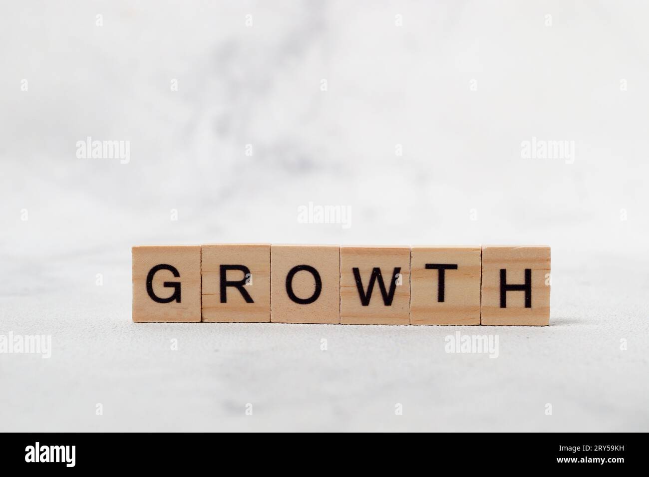 Top view of Growth word on wooden cube letter block on white background ...