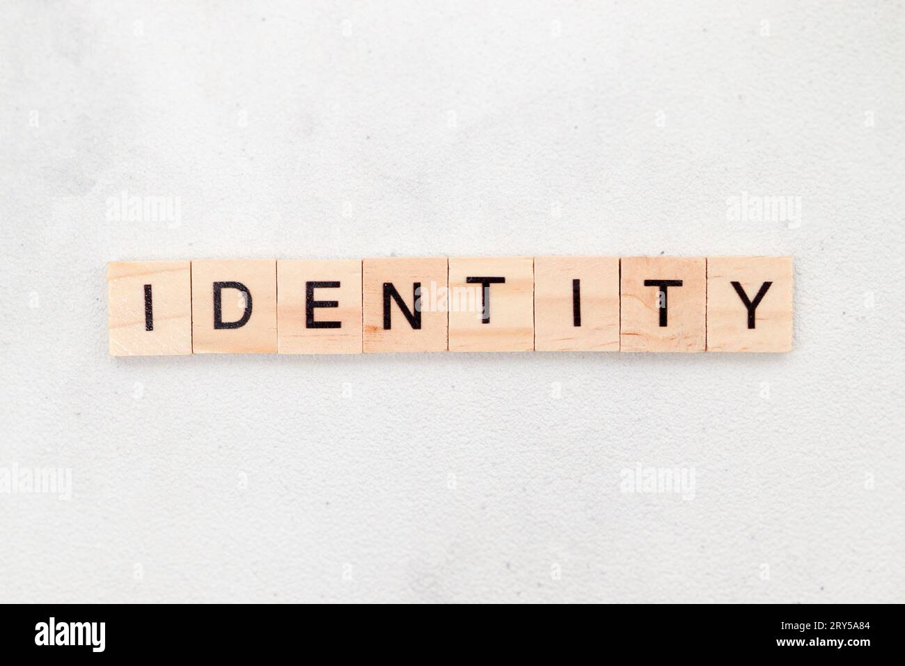 Top view of Identity word on wooden cube letter block on white ...