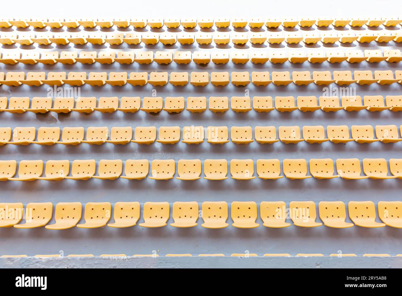 Top view of yellow seats on sport stadium with the chairs are lined up ...