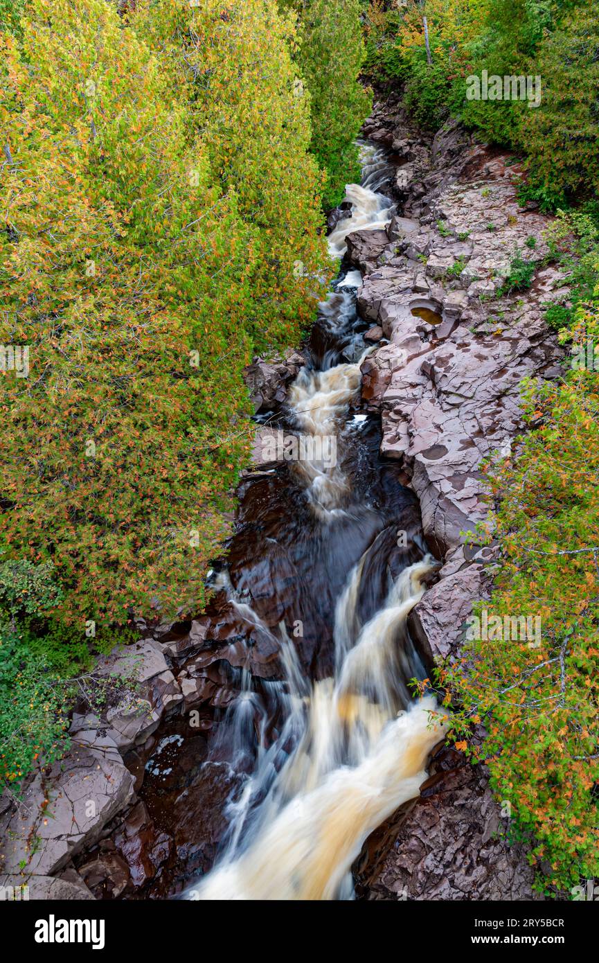 Surrounded by White Cedar (arborvitae) trees, the Poplar River cascades ...