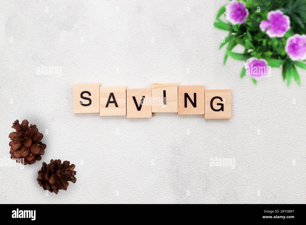 Top view of Saving word on wooden cube letter block on white background ...