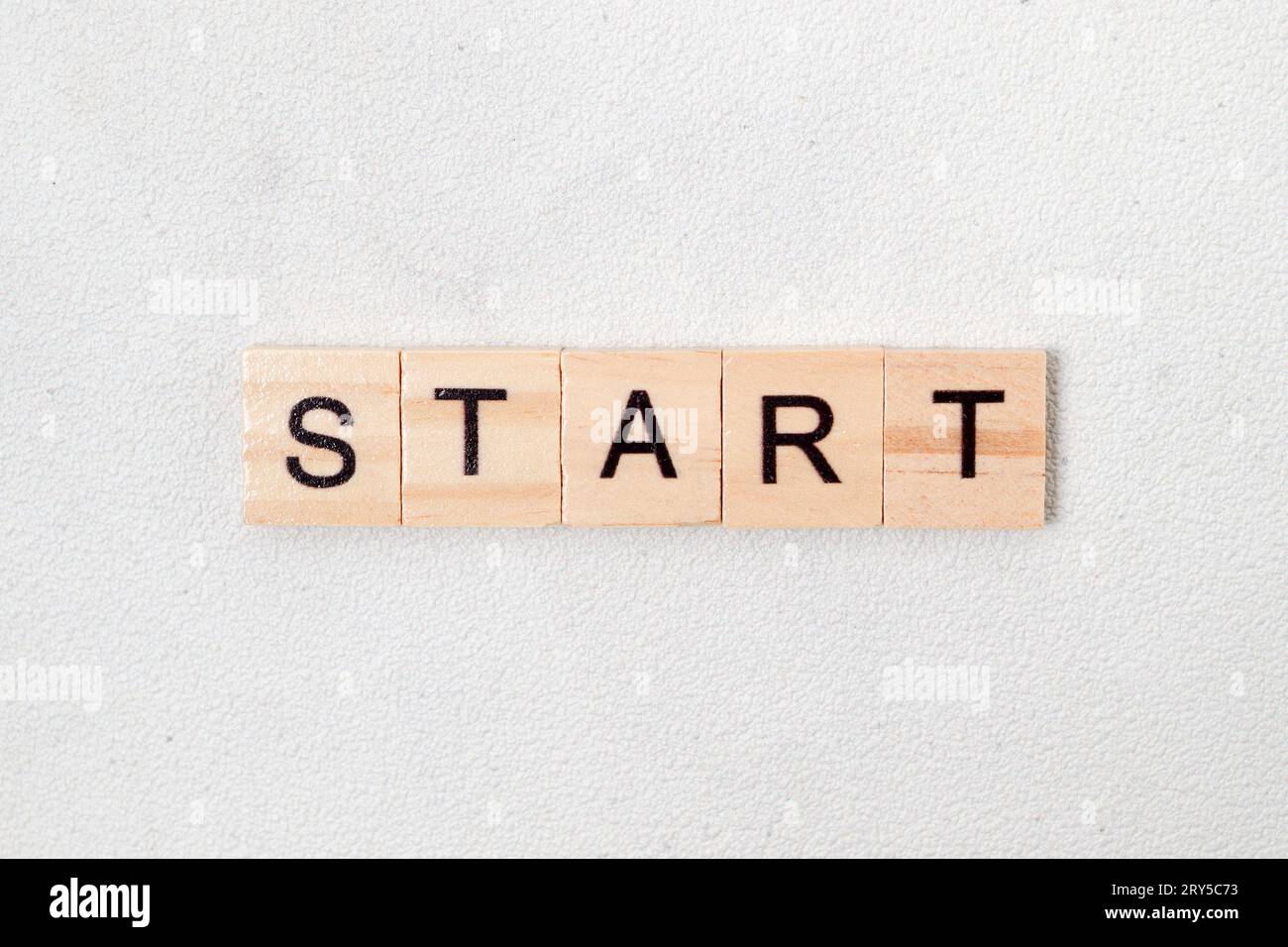 Top view of Start word on wooden cube letter block on white background ...