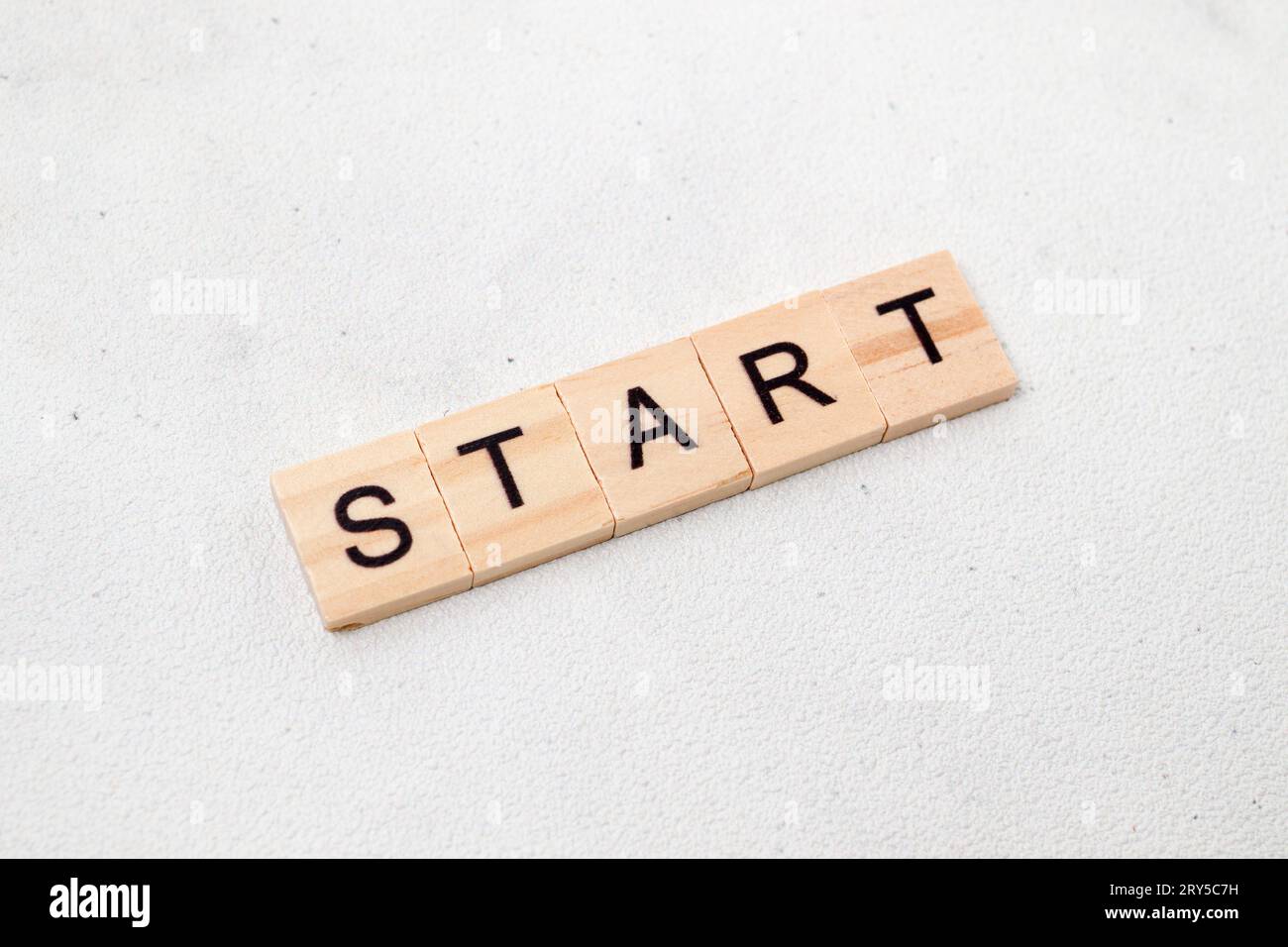 Top view of Start word on wooden cube letter block on white background ...