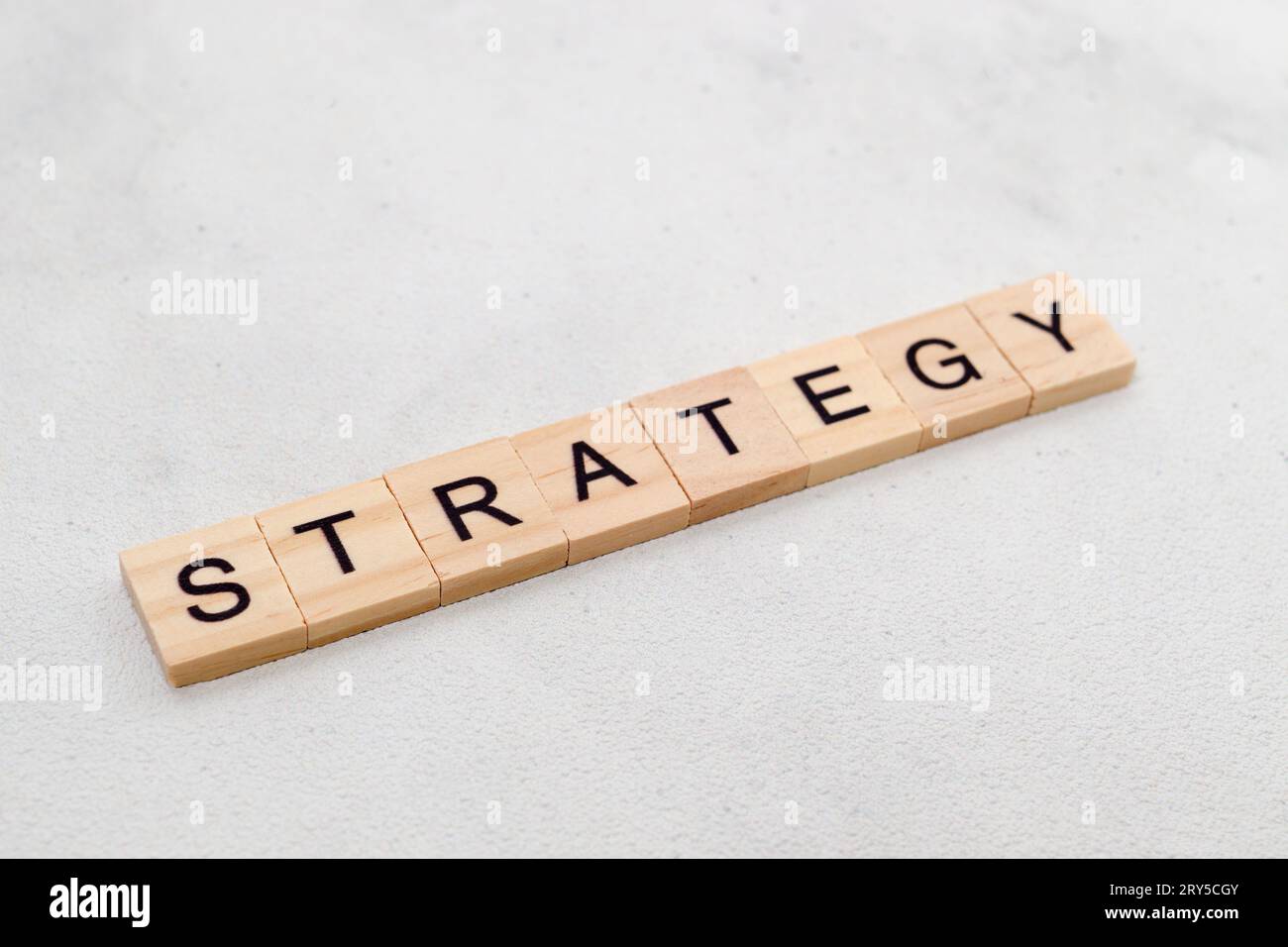 Top view of Strategy word on wooden cube letter block on white ...