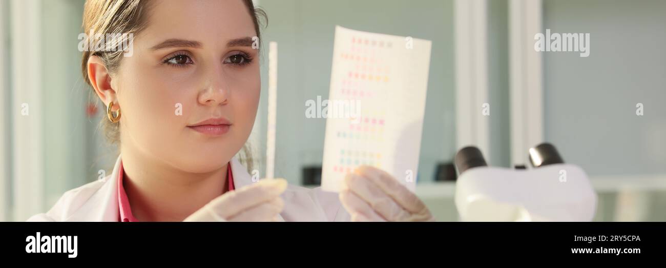 Woman checks result of sample examination under microscope Stock Photo ...