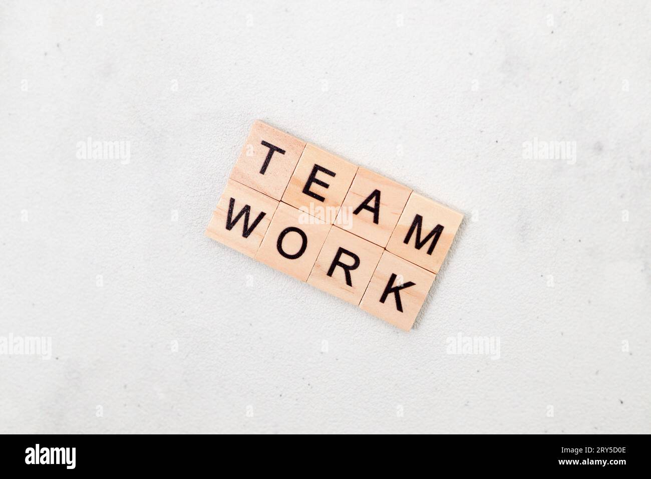 Top view of Teamwork word on wooden cube letter block on white ...