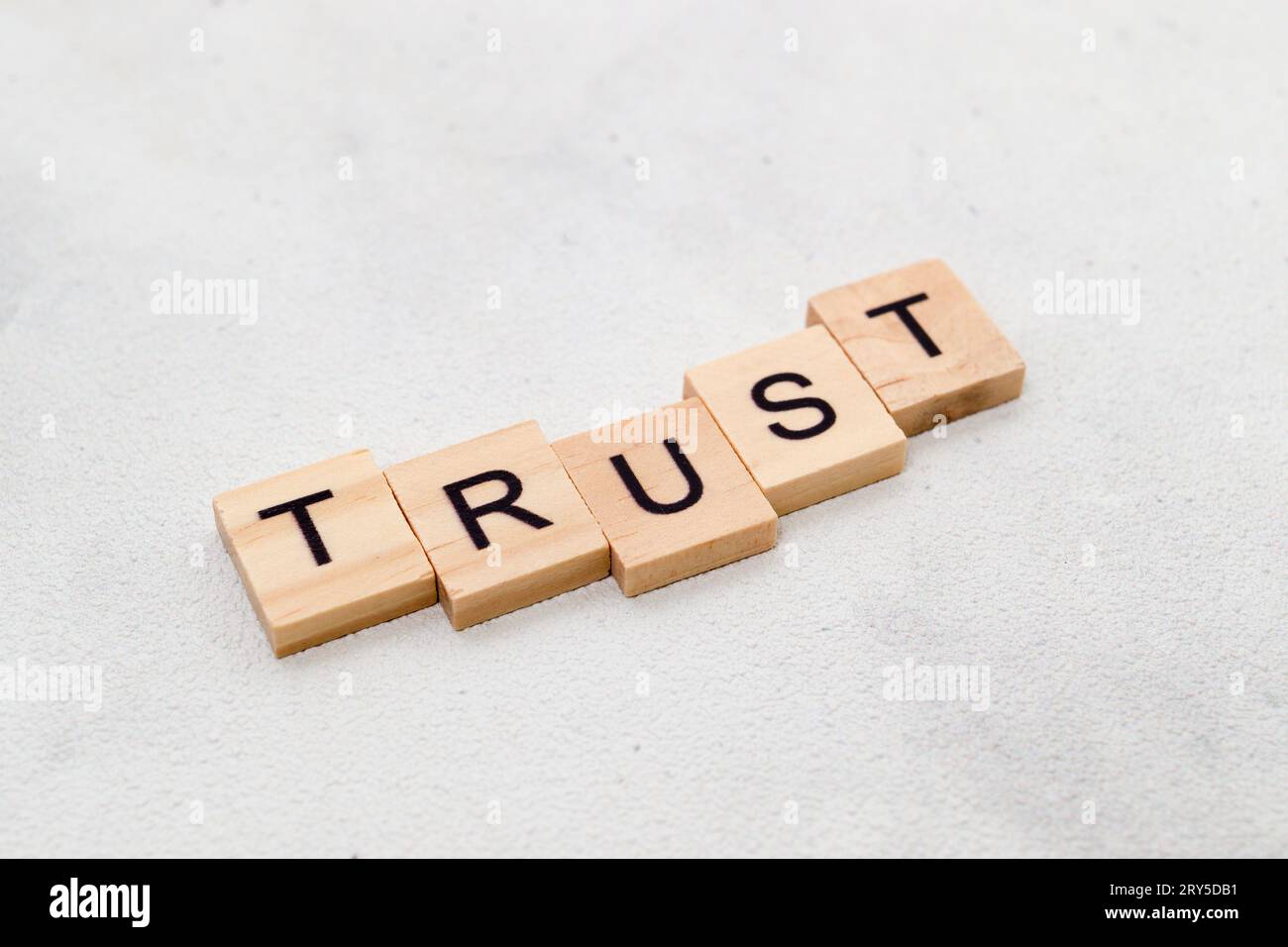 Top view of Trust word on wooden cube letter block on white background ...