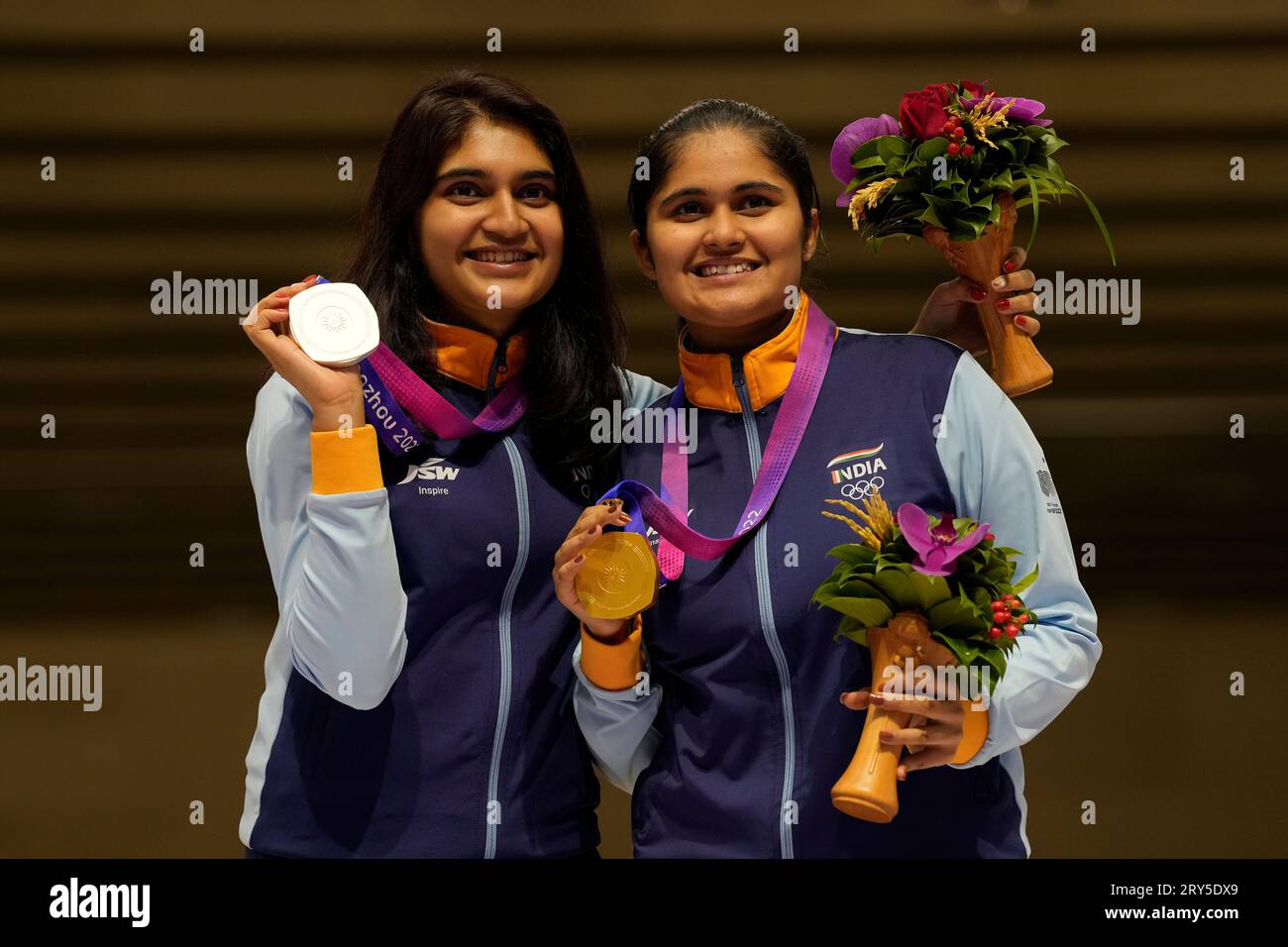 From left, silver medalist Esha Singh of India and gold medalist Palak ...