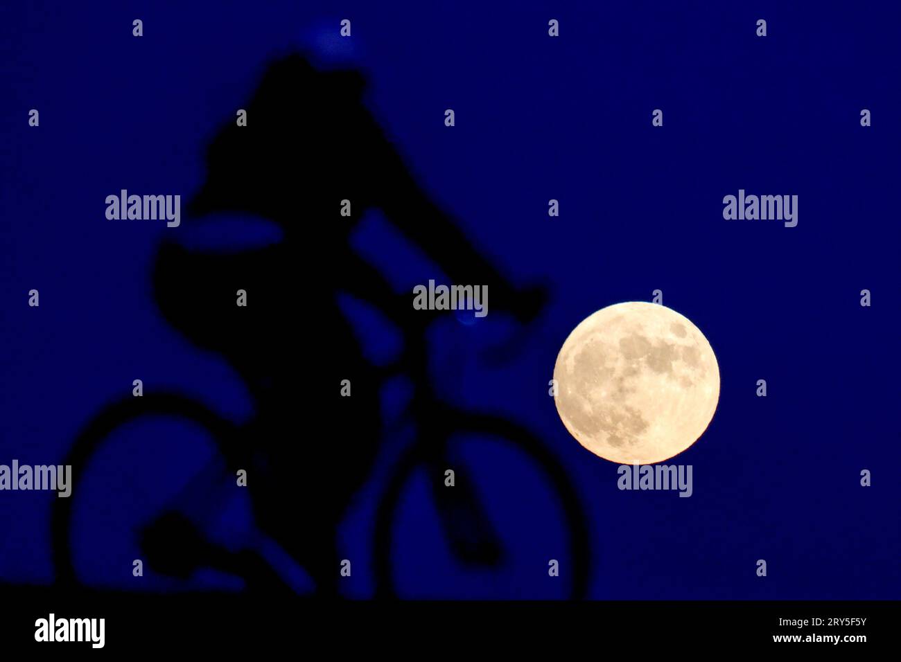 Los Angeles, United States. 28th Sep, 2023. A cyclist rides past as an ...