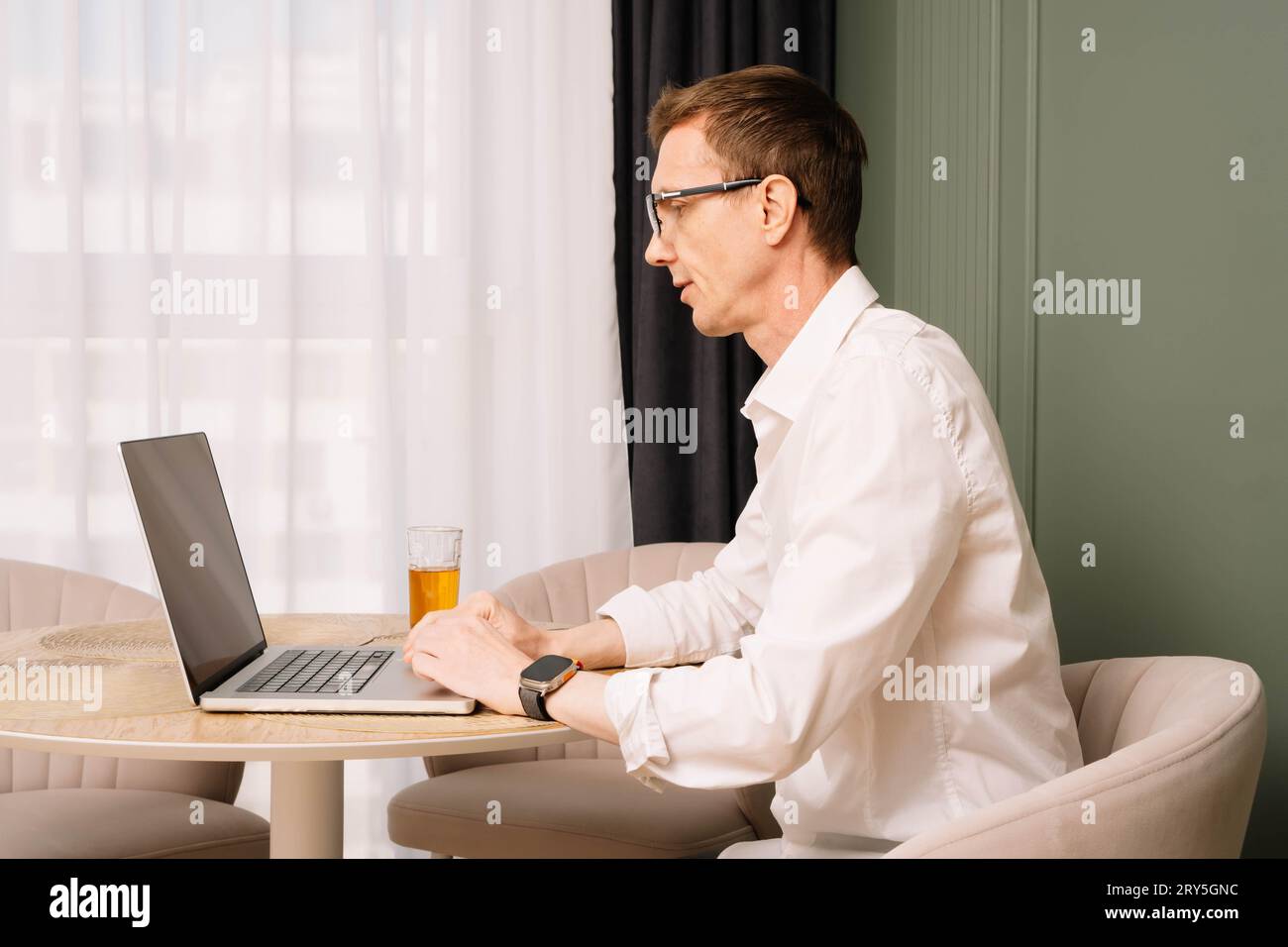 Thin workman in glasses and white shirt working hard at computer ...