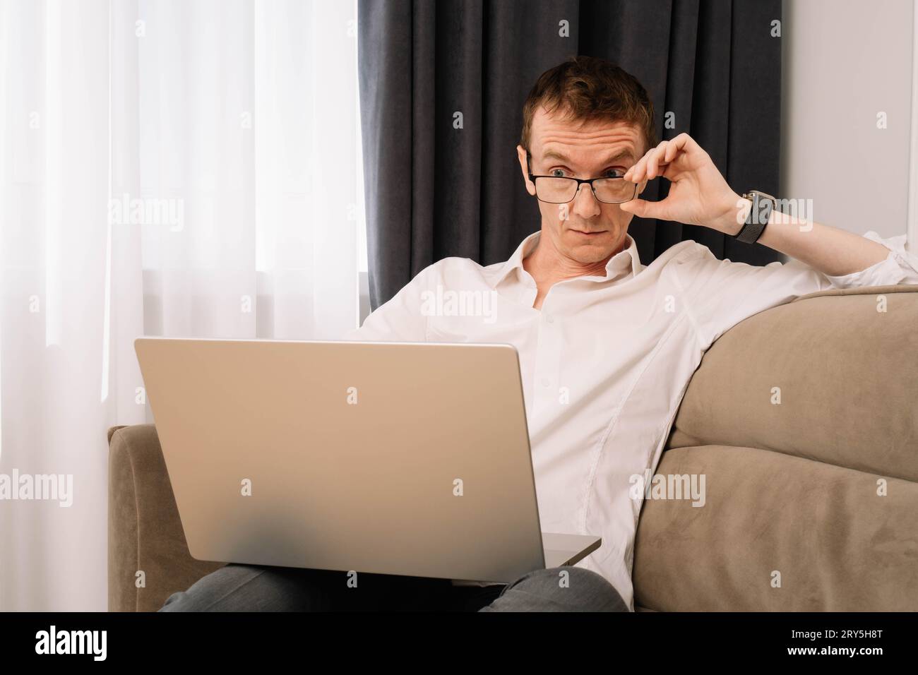 Mature business human watching screen of laptop with goggle eyes and ...