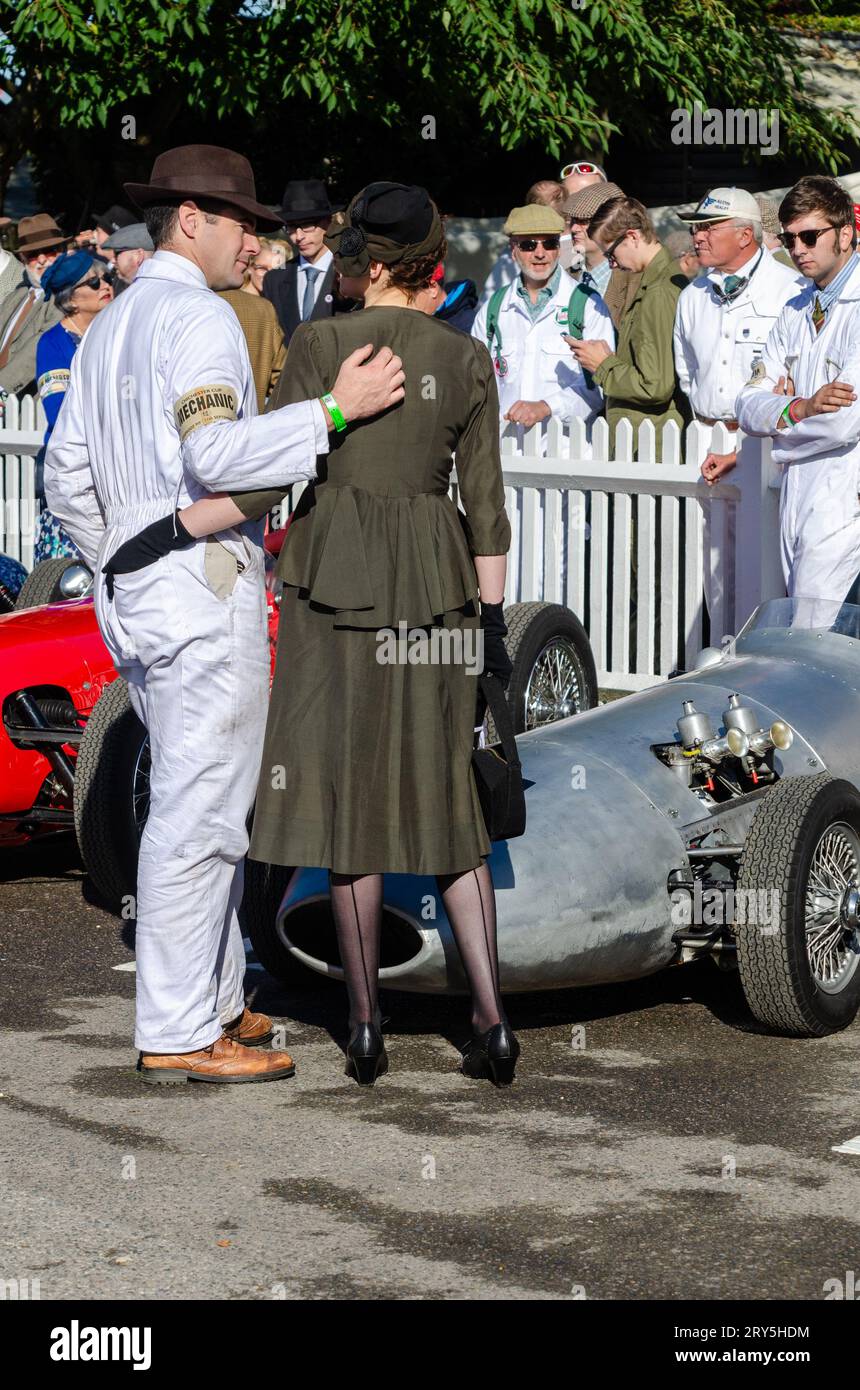 People in period attire at Goodwood Revival motorsport event, with ...