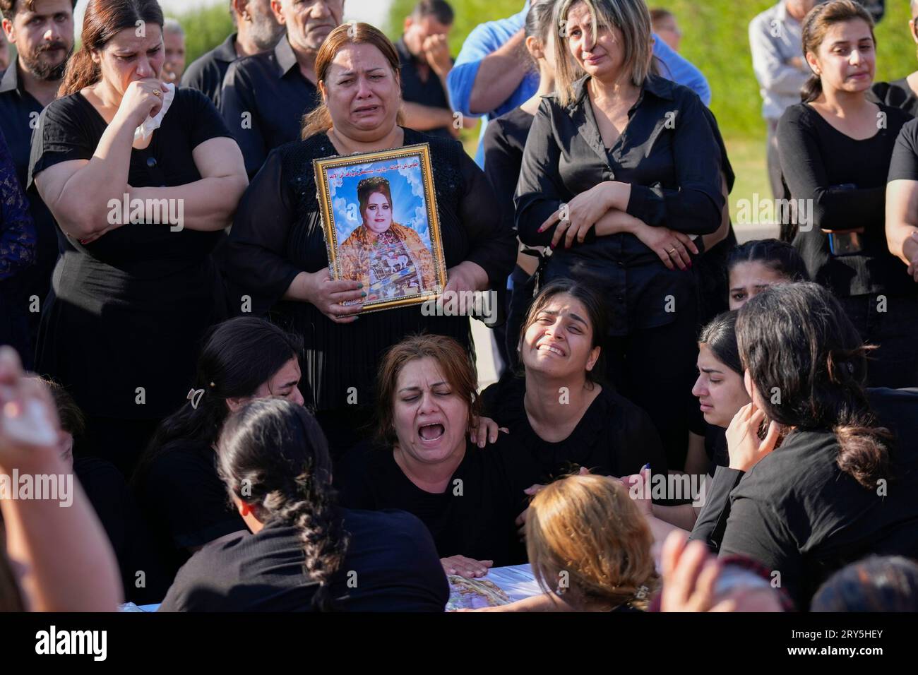 Friends and relatives attend a funeral for the victims who died in a ...