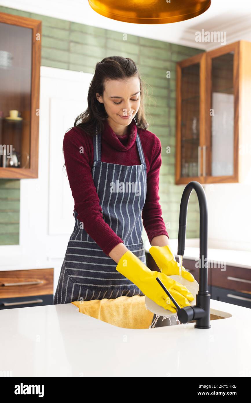 Woman wearing apron in kitchen hi-res stock photography and images - Alamy