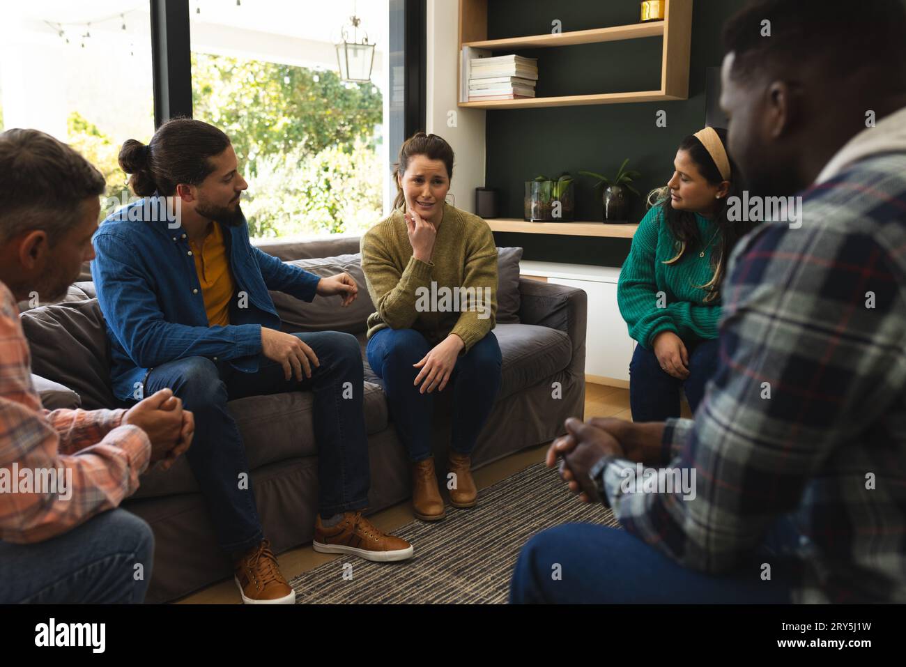 Diverse group of friends talking and supporting each other on therapy ...