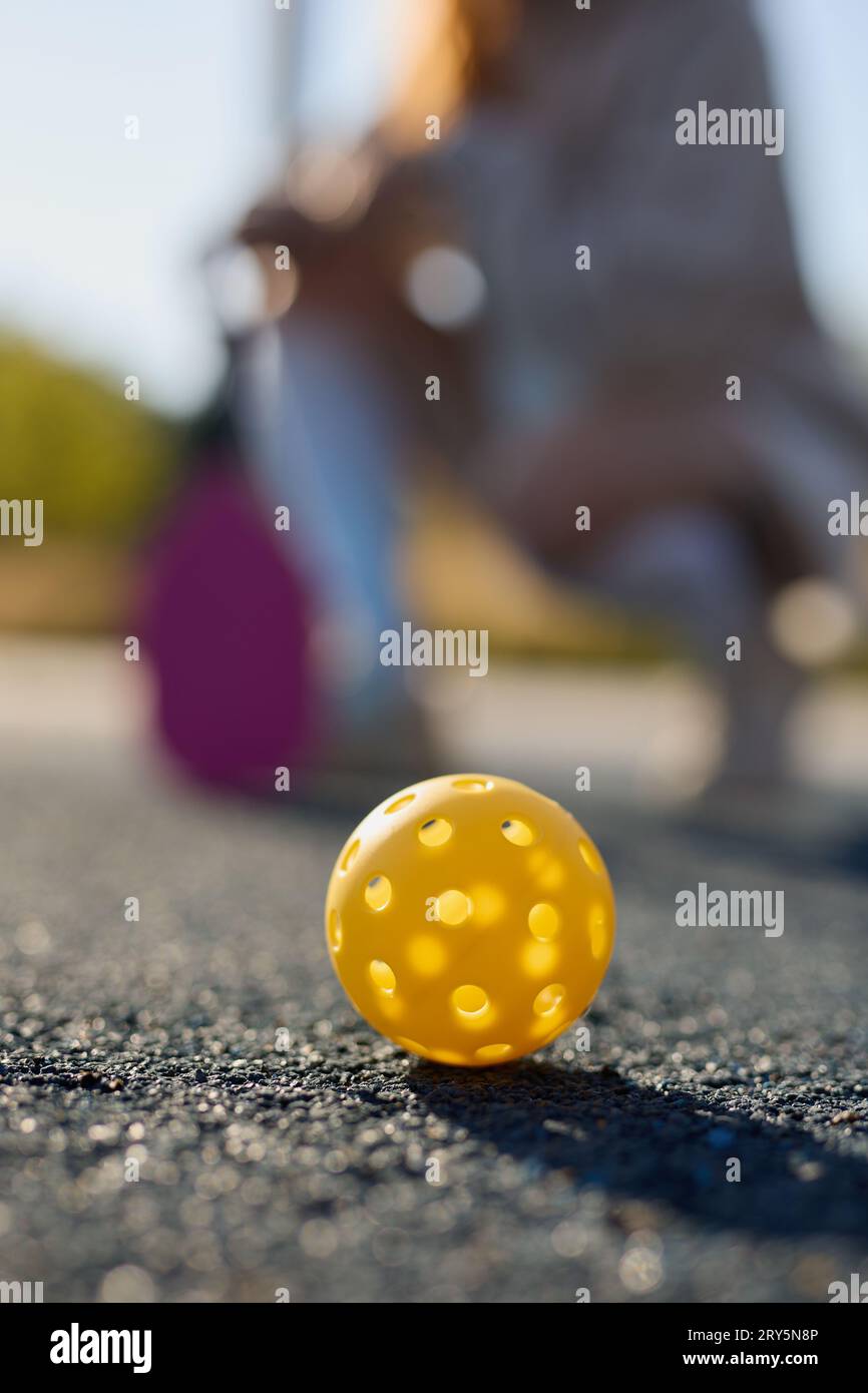 Pickle ball on the ground. Pickler athlete on the background Stock ...