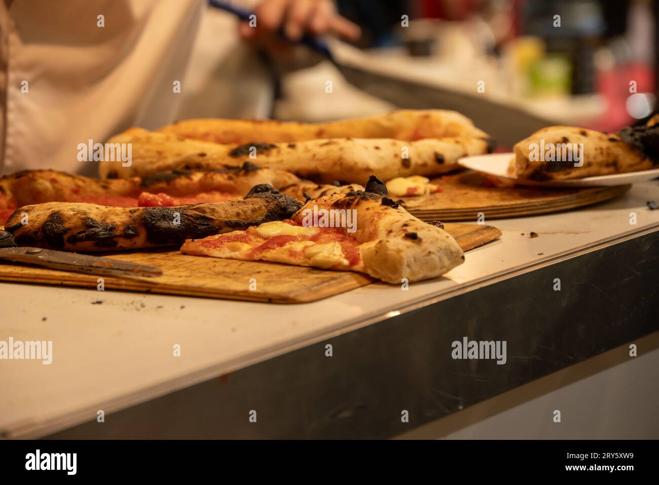 On the table are slices of Neapolitan-style mozzarella cheese pizza ...