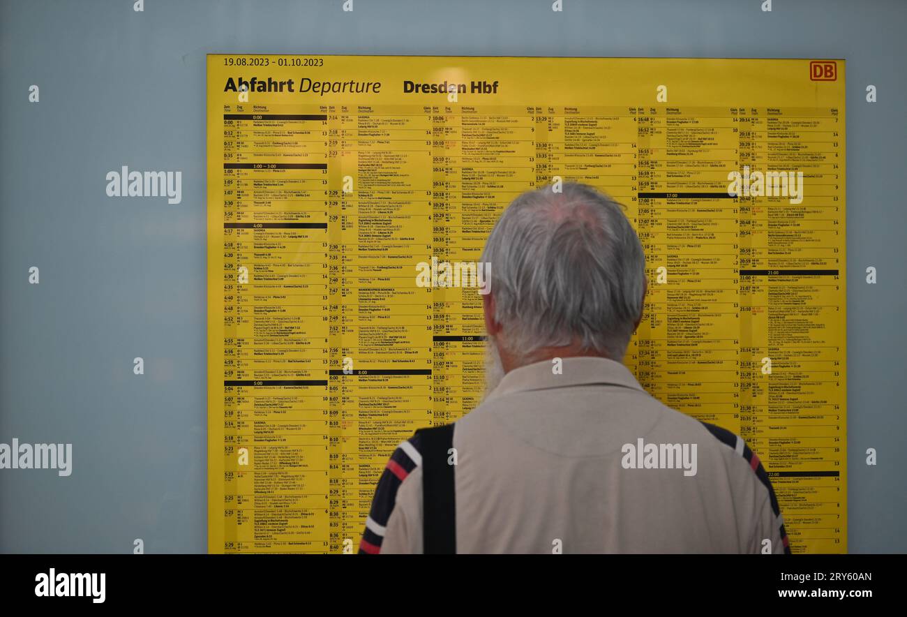 Dresden, Germany. 29th Sep, 2023. A man stands in front of a timetable ...